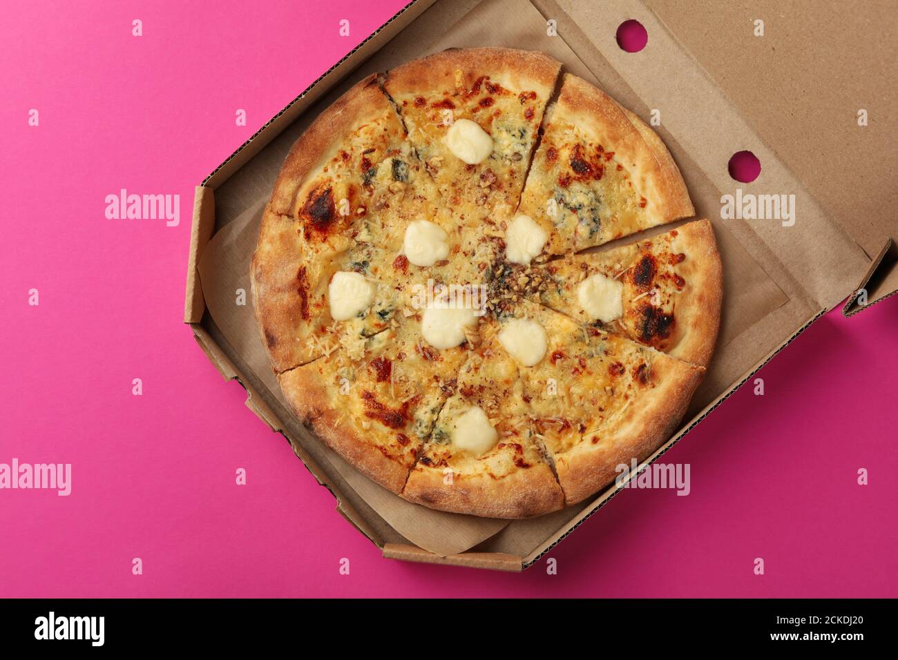 Cheese pizza in carton box on violet background Stock Photo - Alamy