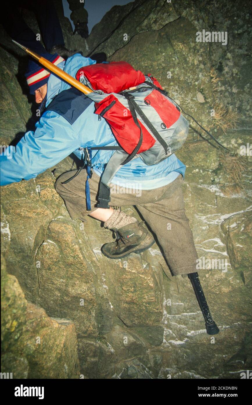 A one legged man scrambling on Striding Edge on Helvellyn, Lake ...