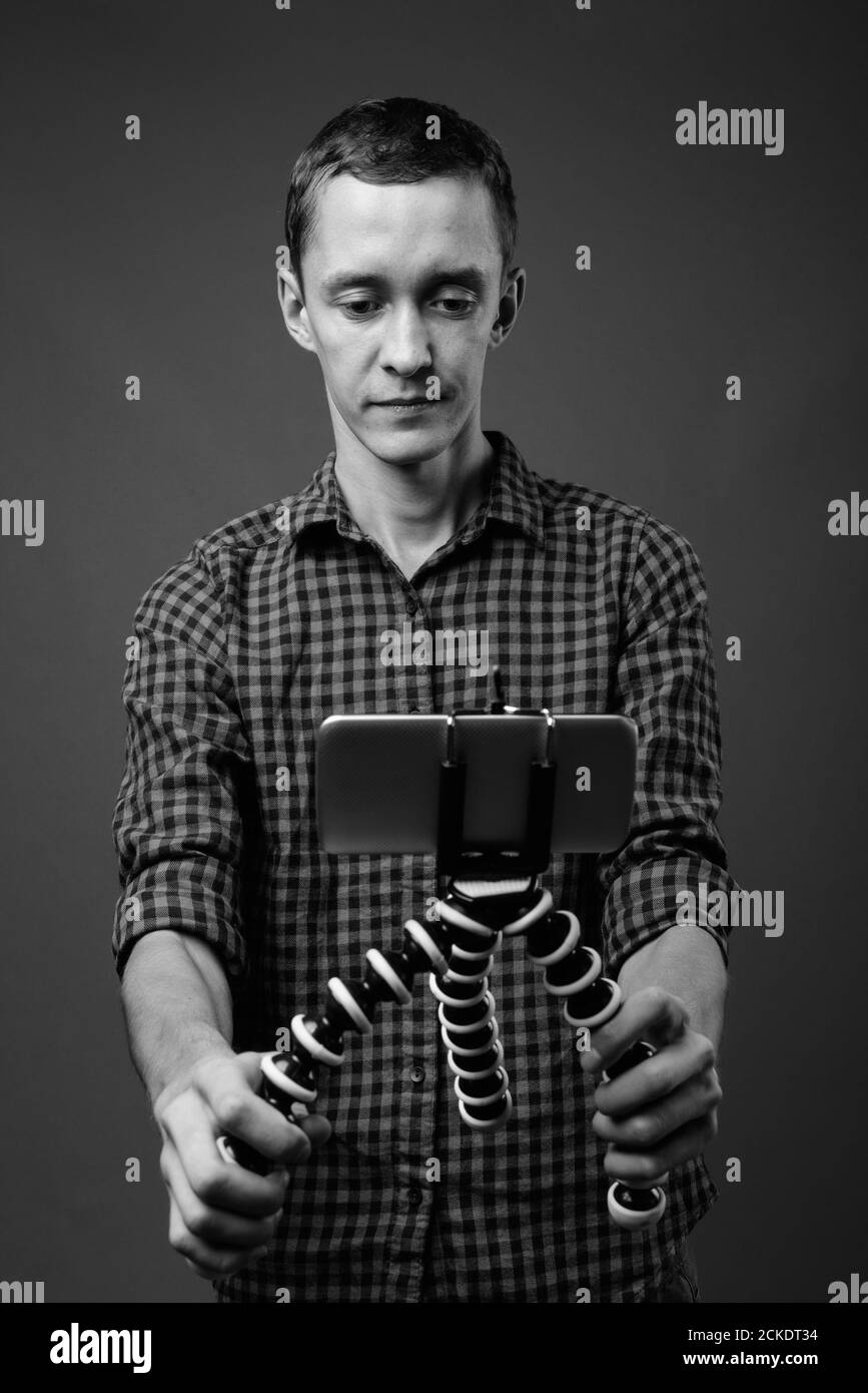 Portrait of young hipster man vlogging with phone Stock Photo - Alamy