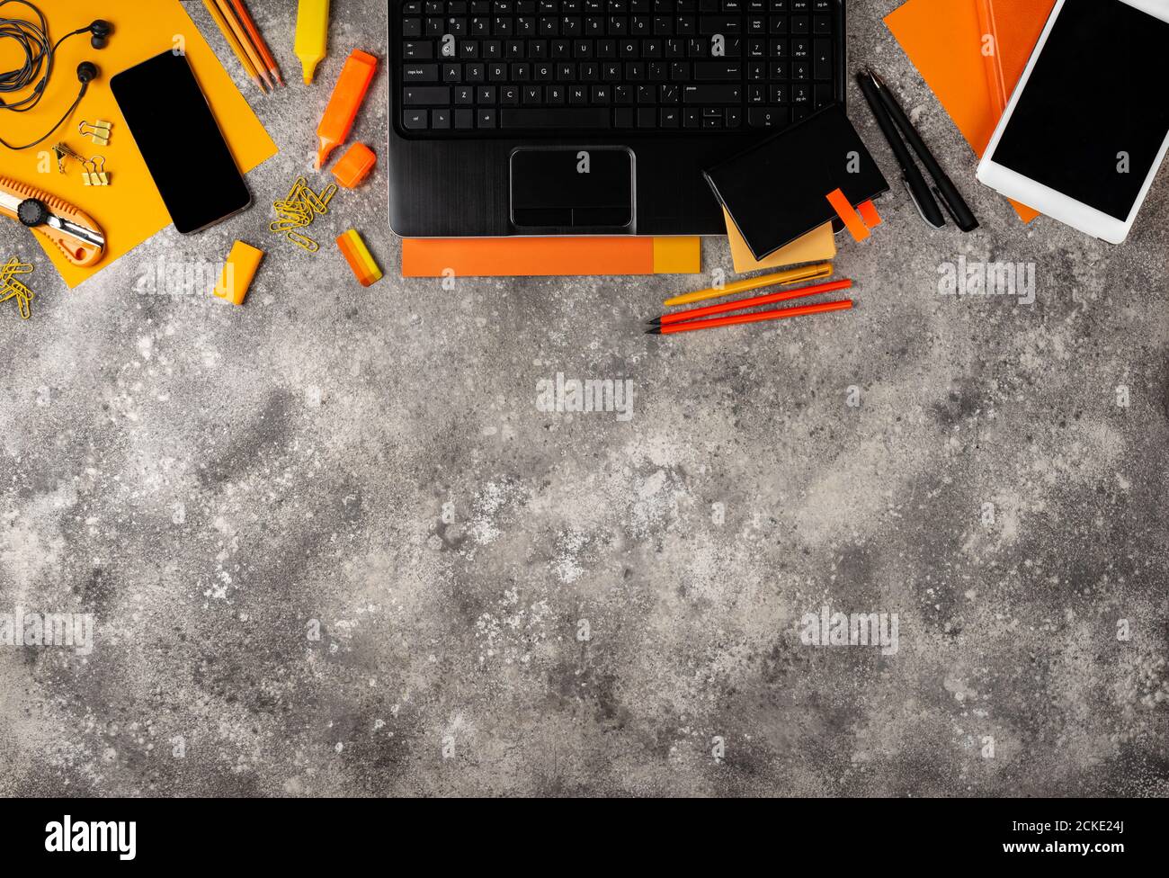 Border from office supplies and gadgets on the desk. Top view with copy ...