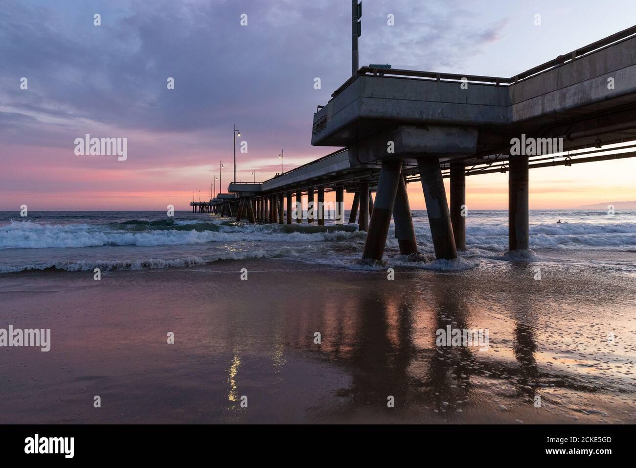 Mesmerizing view of a pier at the beach in California during sunset ...