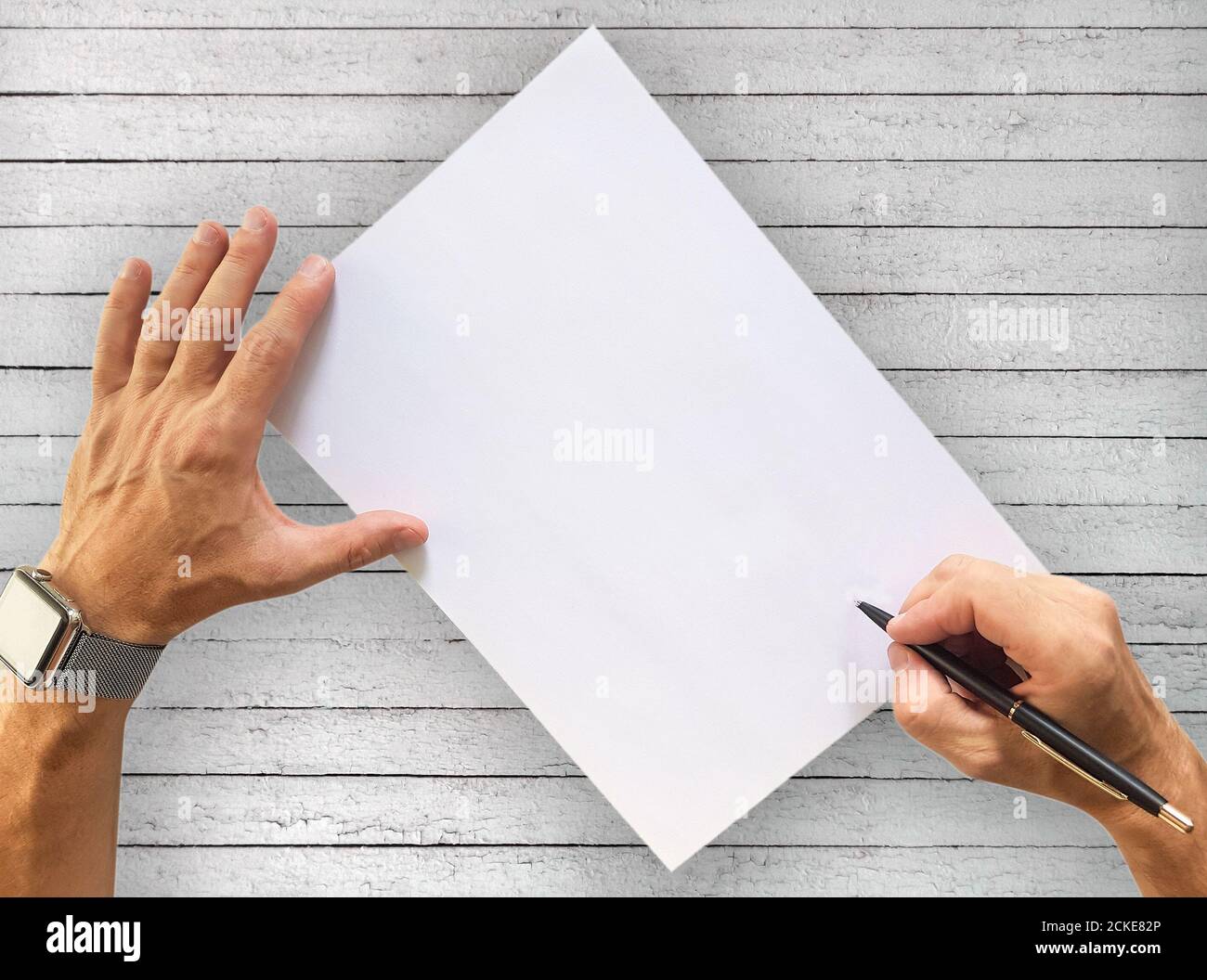 Businessman male writing a letter at wooden desk Stock Photo - Alamy