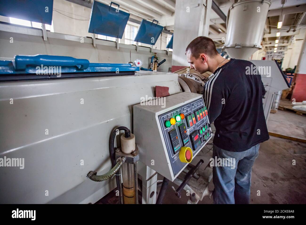 Modern plastic pipes production line. Operator worker controlling ...