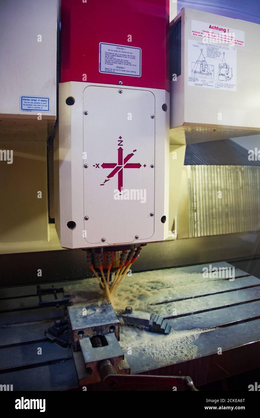 Cooling by water cutting CNC machine tool in process Stock Photo - Alamy