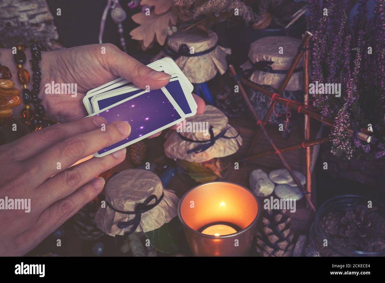Woman hand is holding deck of tarot or oracle cards performing ...