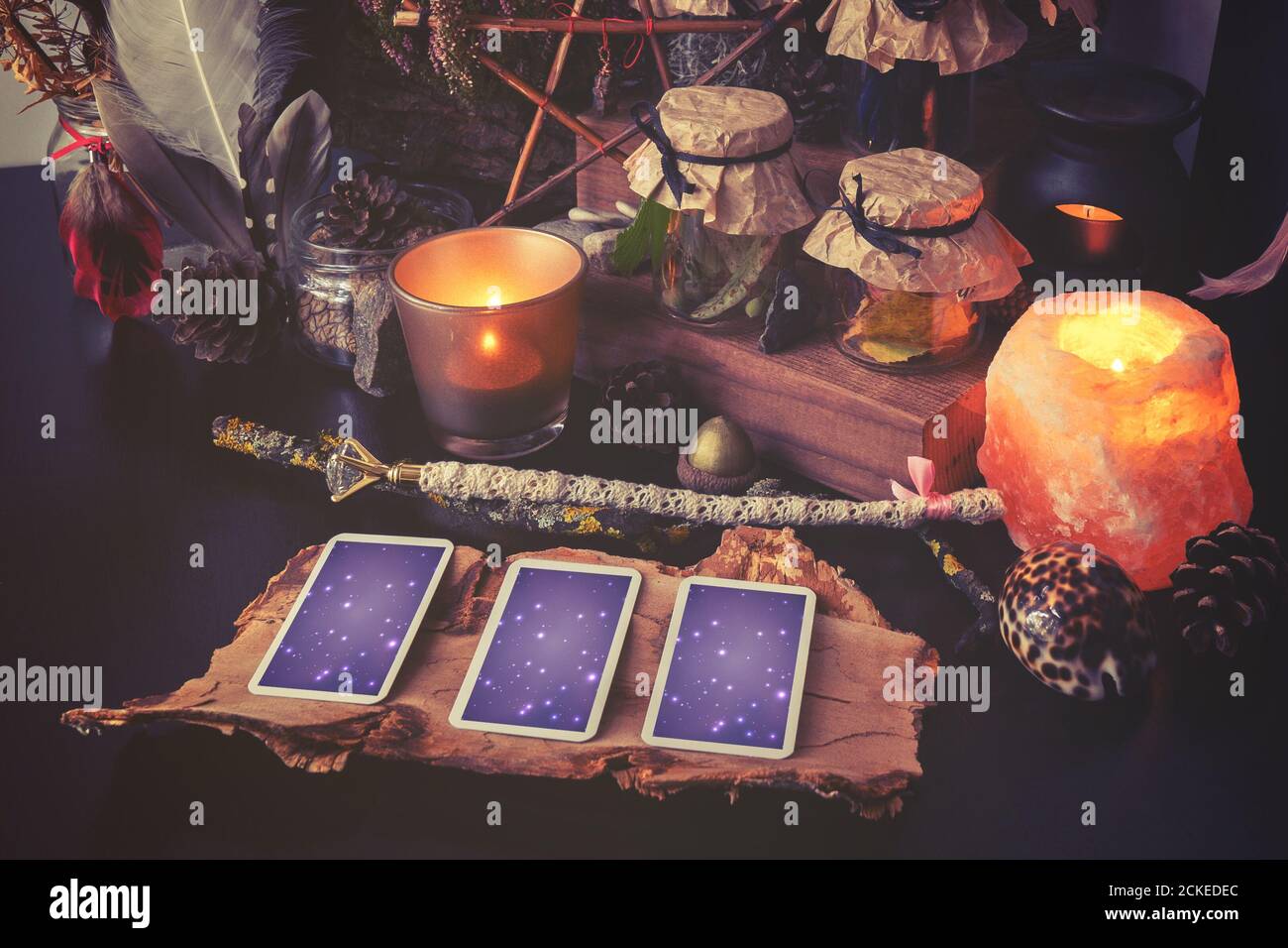 3 Tarot cards spread lying on a black table with magic items. Toned to ...