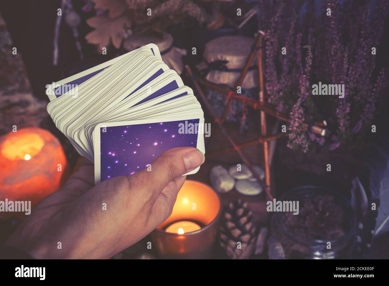 Woman hand is holding deck of tarot or oracle cards performing ...