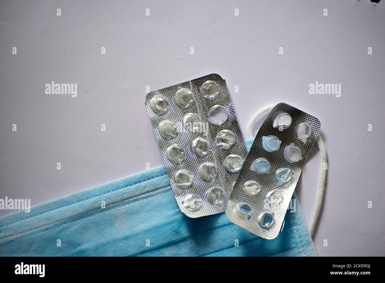 surgical mask and empty tablet capsule script on gray background Stock ...