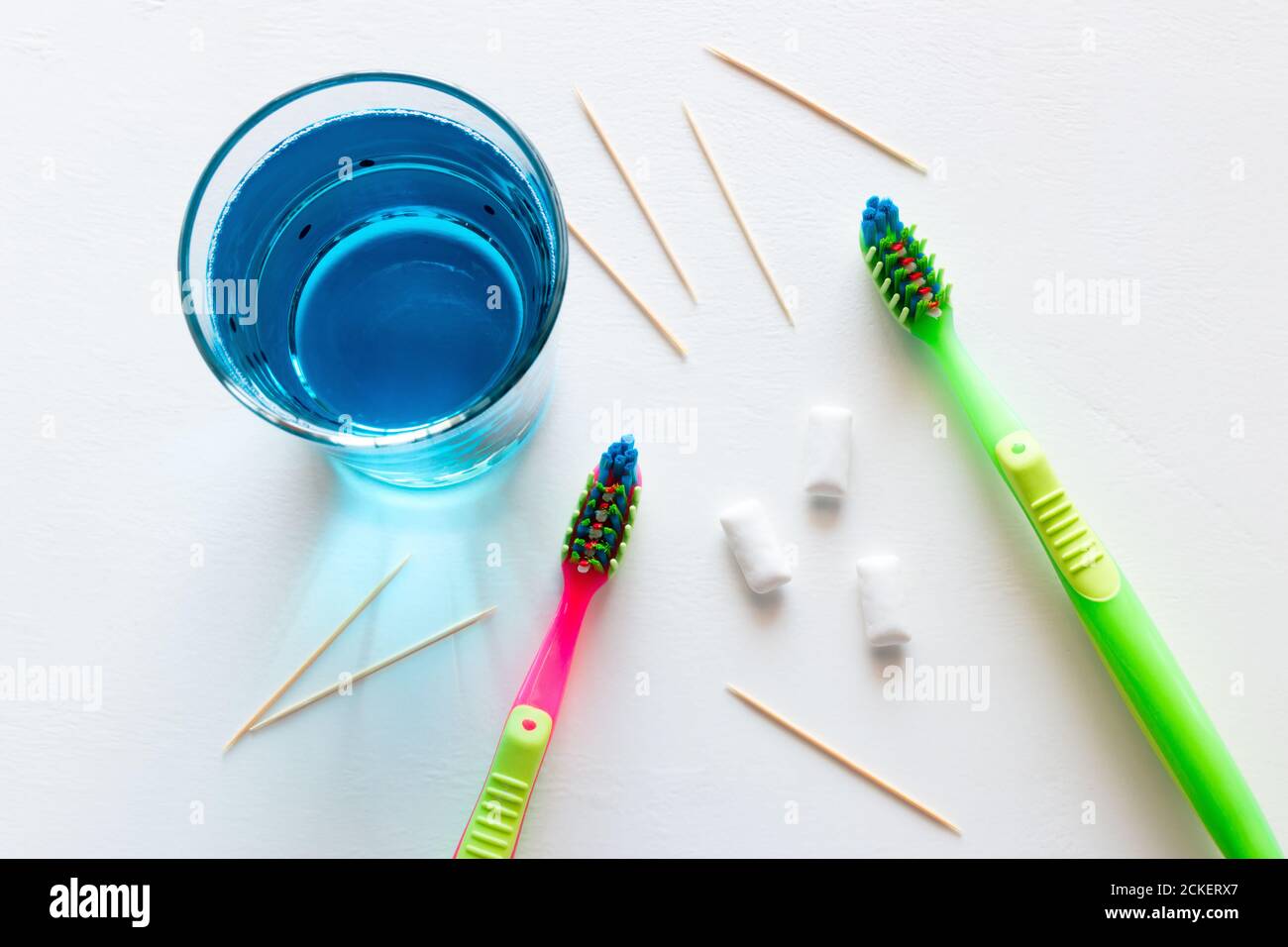 toothbrushes, rinse, chewing gum and toothpicks on white background ...