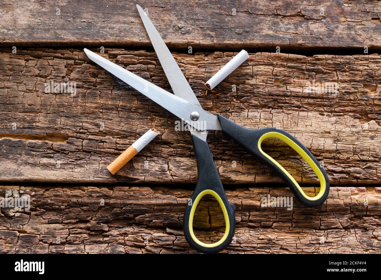 cut cigarette and scissors on a wooden background Stock Photo - Alamy