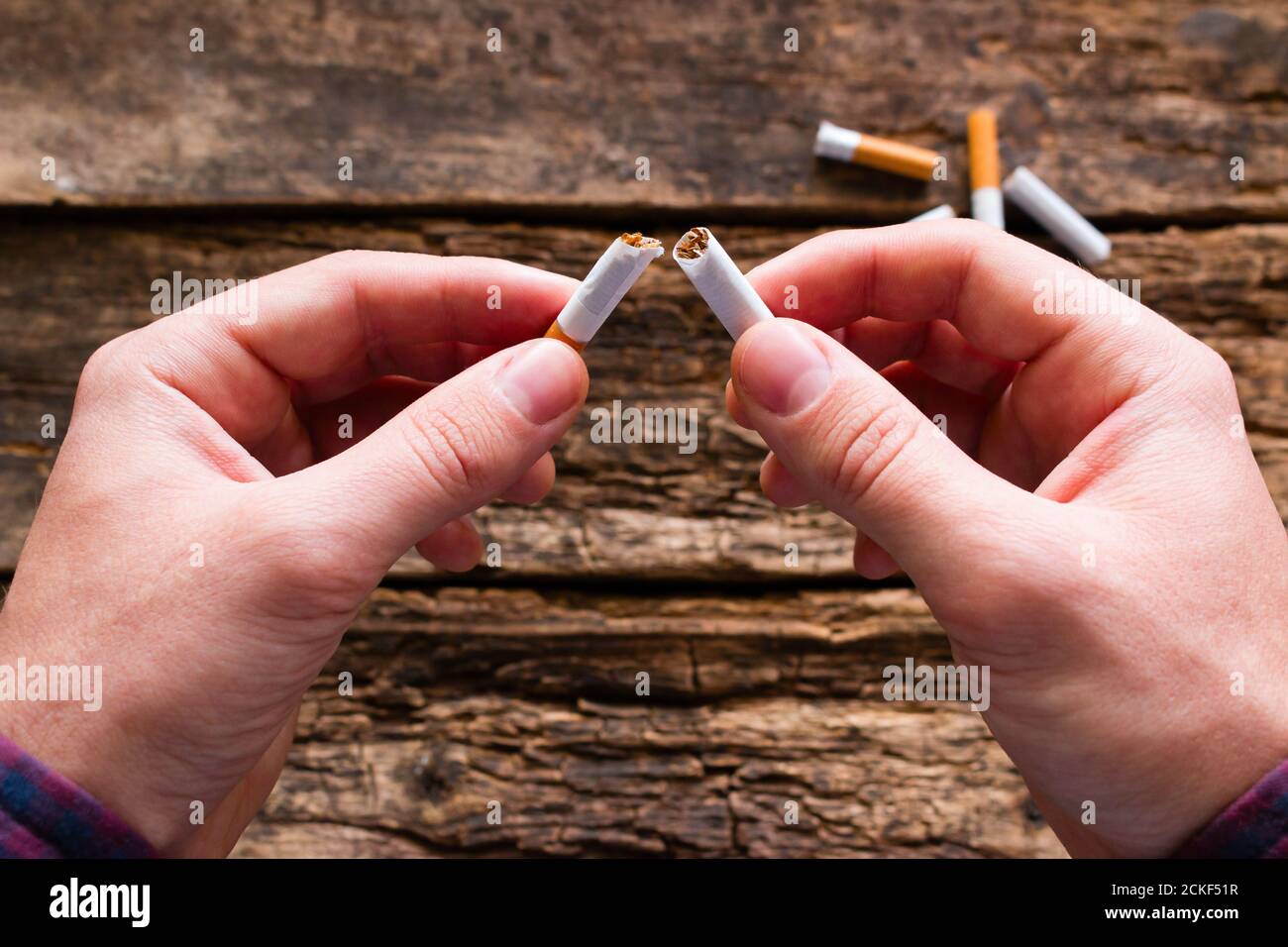 Smoker breaks a cigarette. stop smoking concept Stock Photo - Alamy
