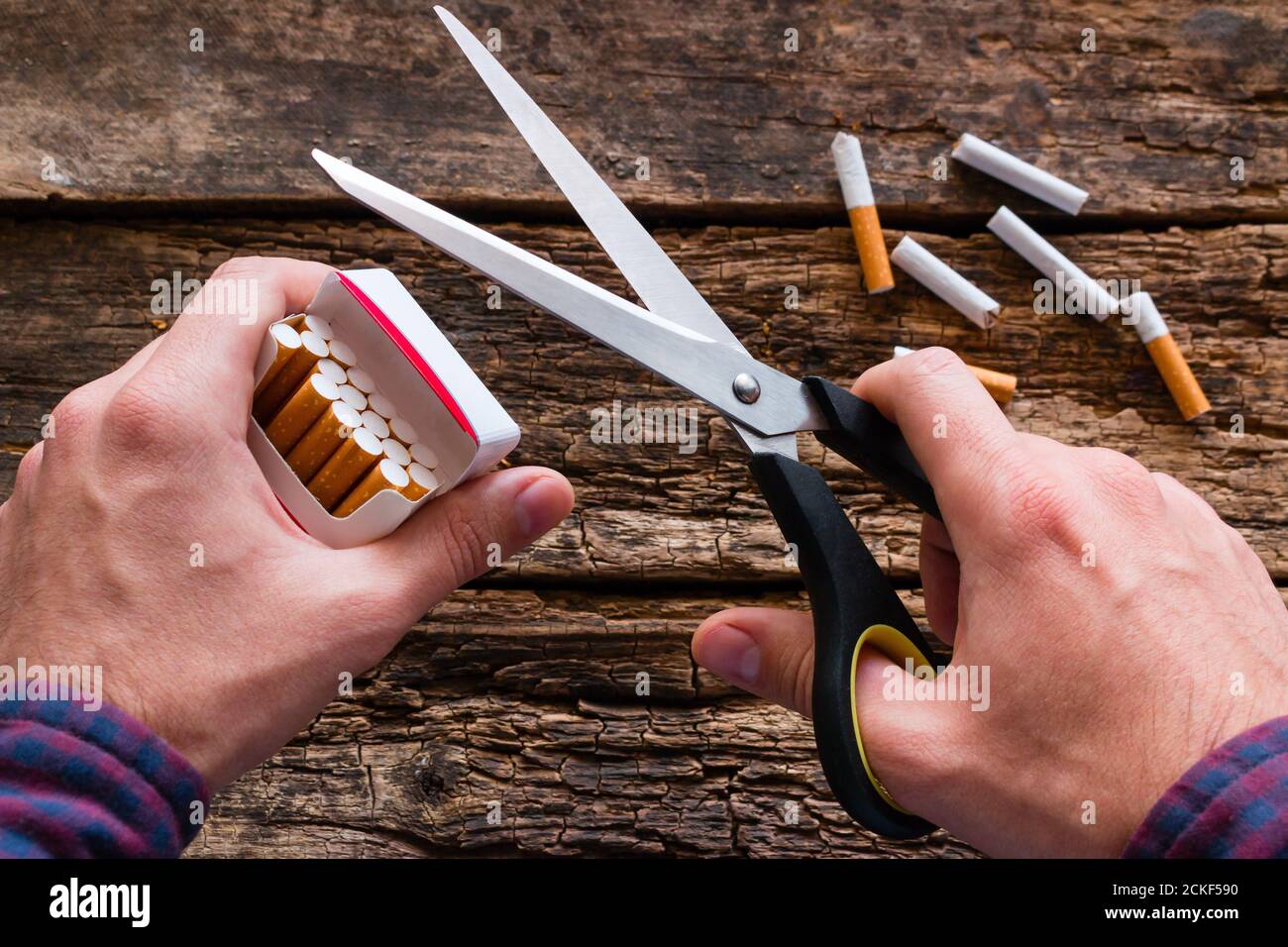 smoker quit smoking and scissors cutting cigarettes Stock Photo - Alamy