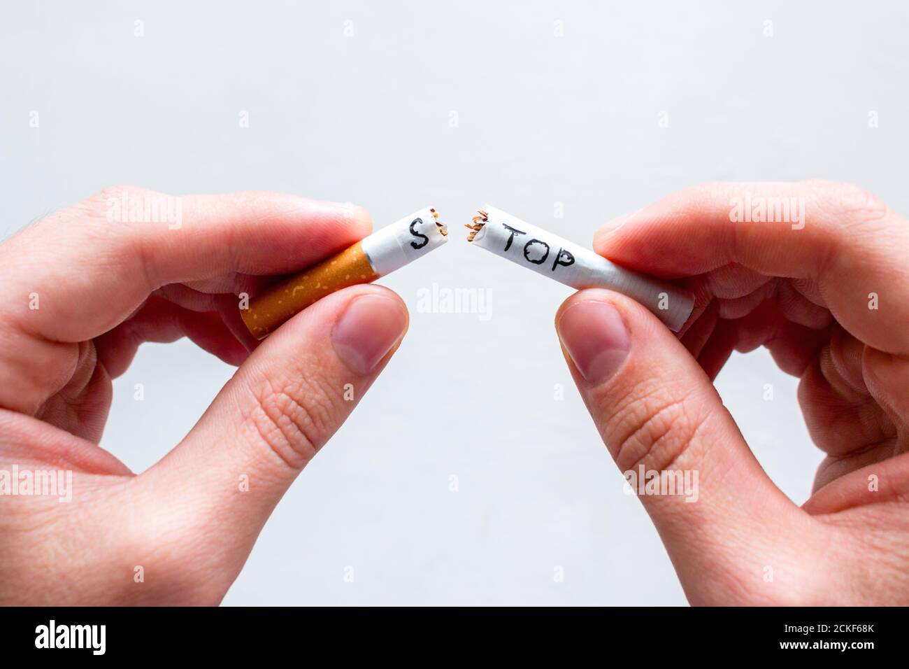 smoker breaks a cigarette with the word stop. concept stop smoking on ...