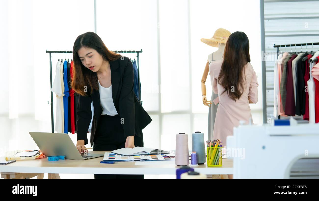 Portrait of young designers working in the garment factory Stock Photo ...