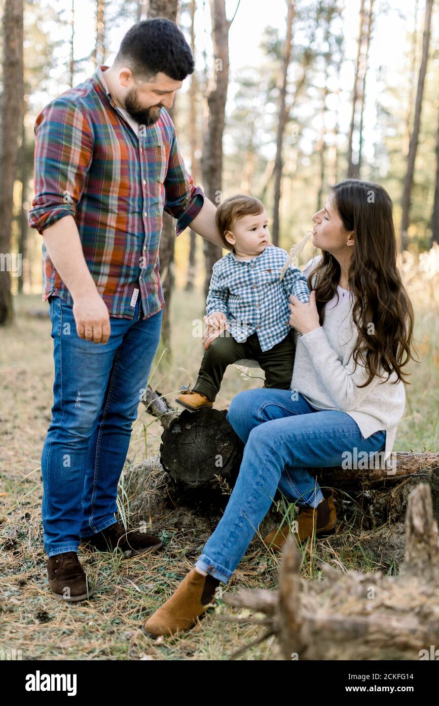 Family walk in the autumn forest. Pretty young mother and her little ...