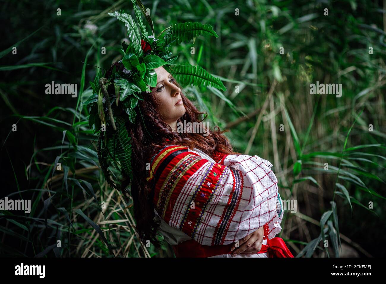 beautiful woman in wreath of wild flowers of flowers in sunny day ...