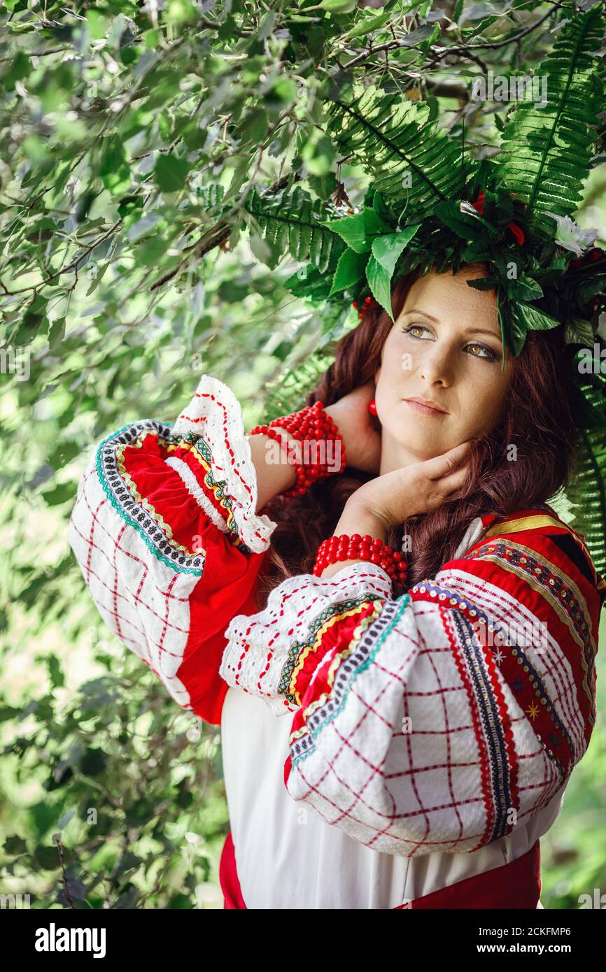 beautiful woman in wreath of wild flowers of flowers in sunny day ...