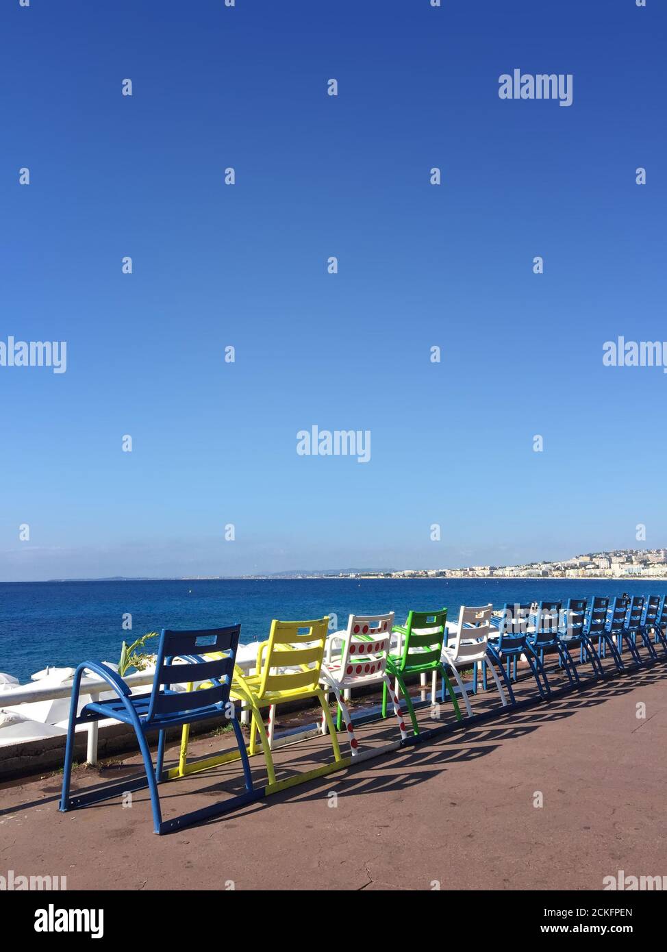 chairs at coastline in nice, France with ocean background Stock Photo ...