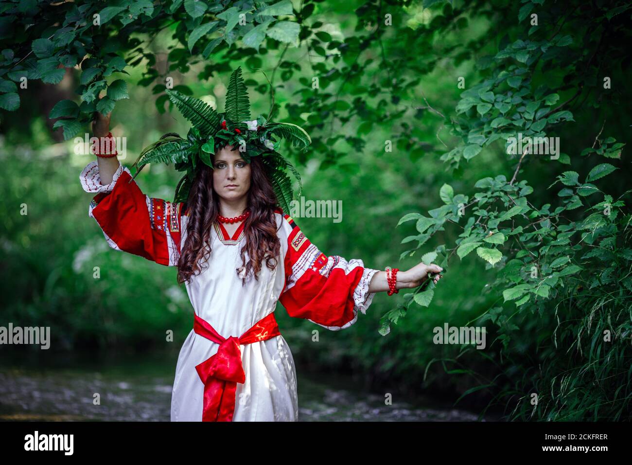 beautiful woman in wreath of wild flowers of flowers in sunny day ...