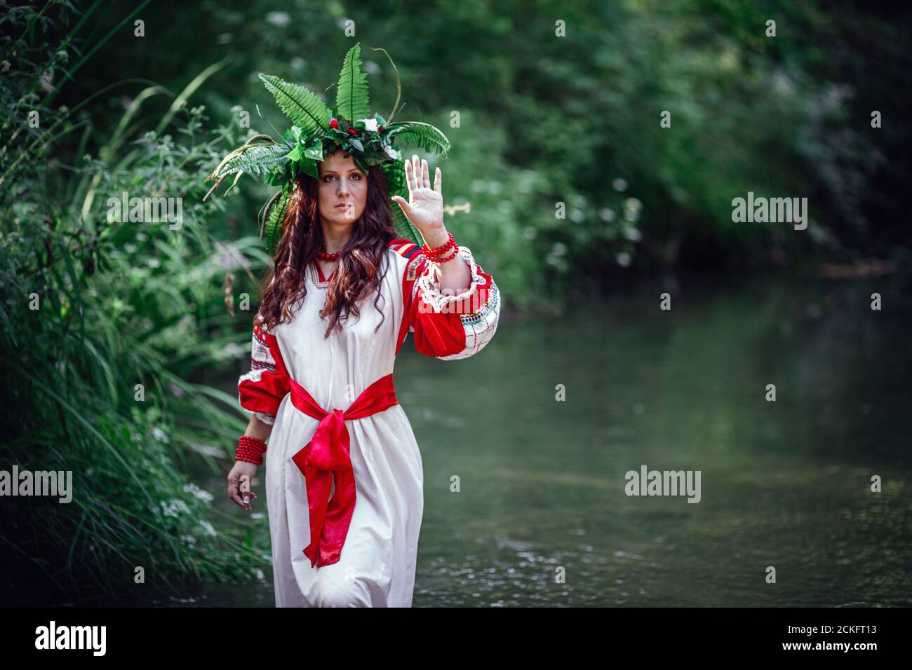 beautiful woman in wreath of wild flowers of flowers in sunny day ...