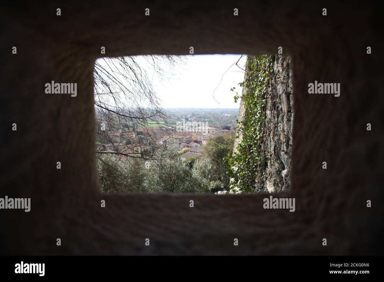 medieval ancient rock slit window from which you can see the view over ...