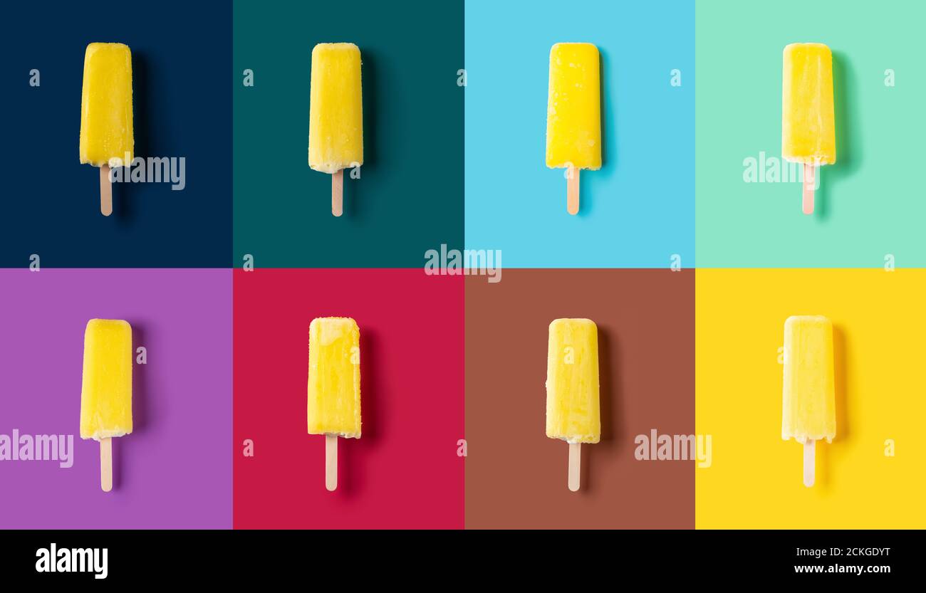 multi color yellow popsicle on a dark blue background Stock Photo - Alamy