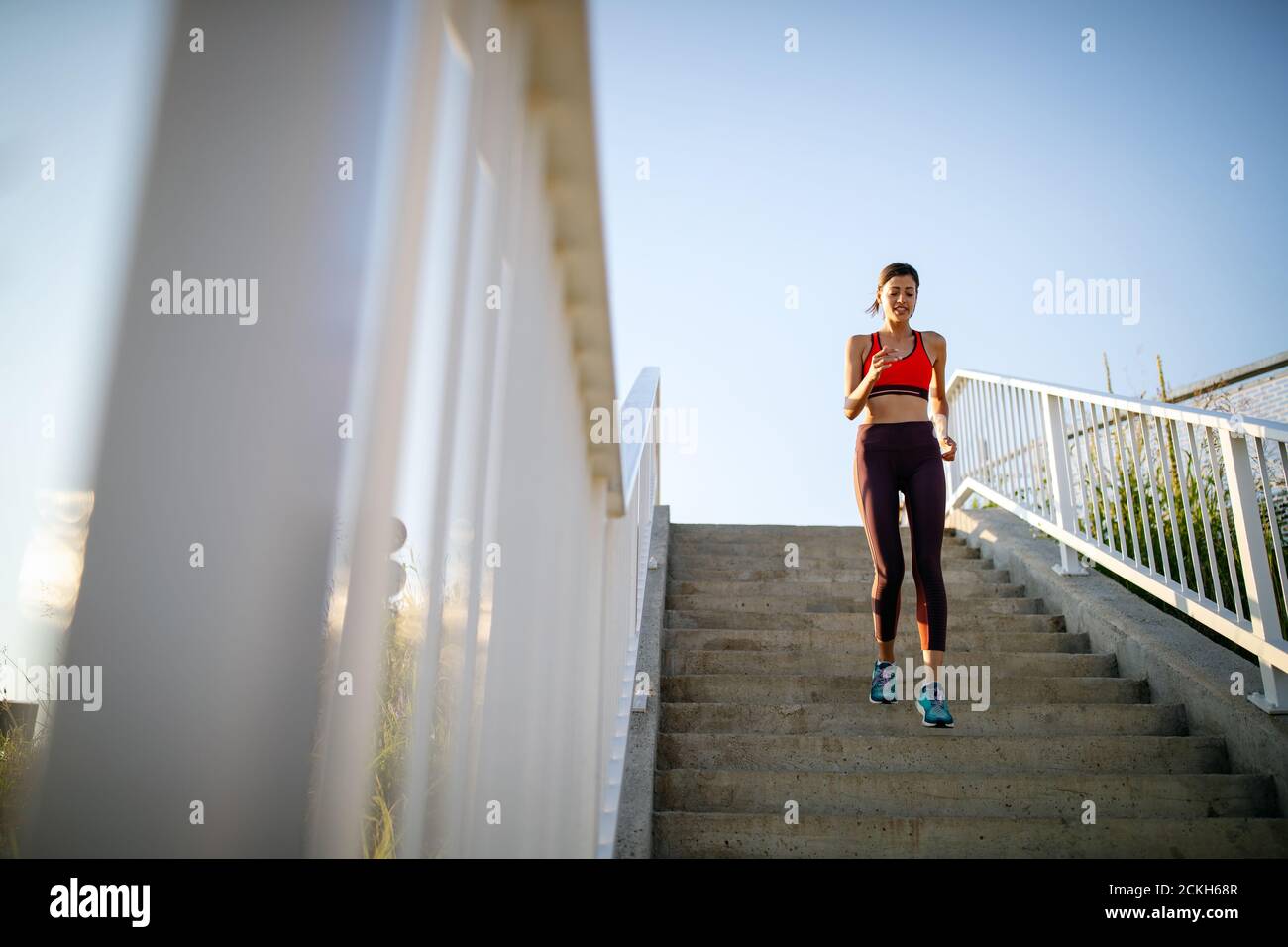 Beautiful fit female runner jogging during outdoor workout Stock Photo ...