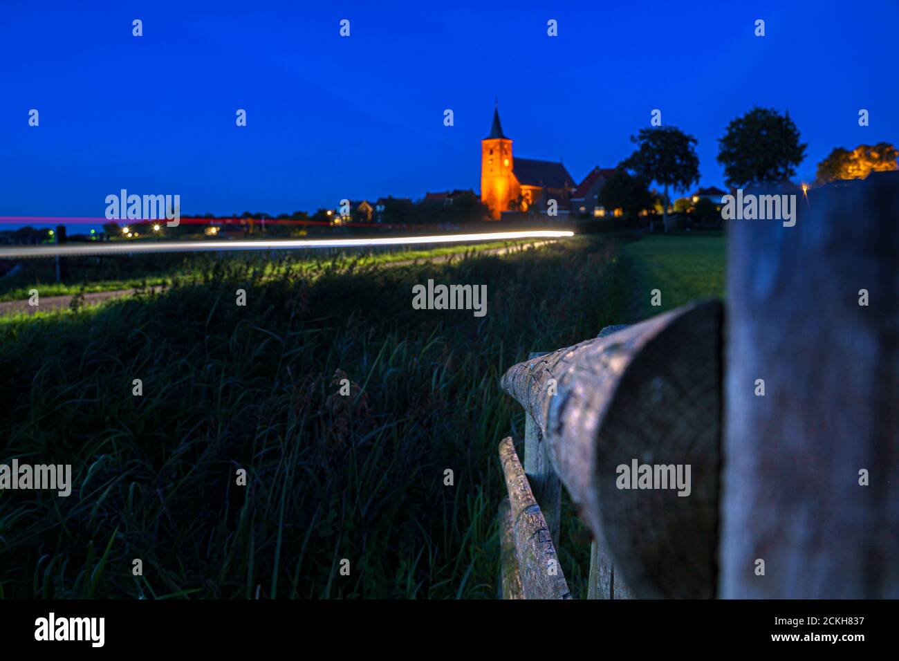 Medieval church in the floodplains on a dike of a Dutch river landscape ...
