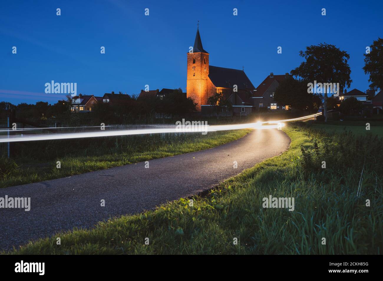 Medieval church in the floodplains on a dike of a Dutch river landscape ...