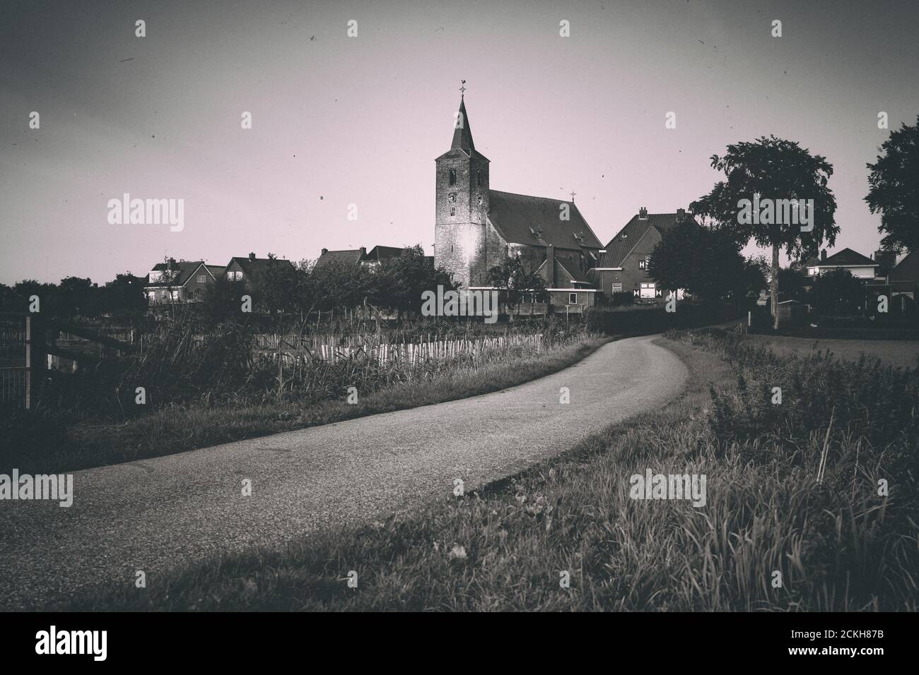Medieval church in the floodplains on a dike of a Dutch river landscape ...
