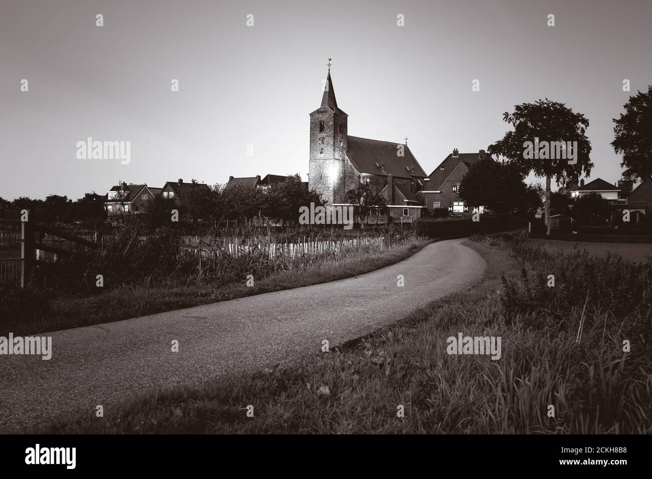 Medieval church in the floodplains on a dike of a Dutch river landscape ...