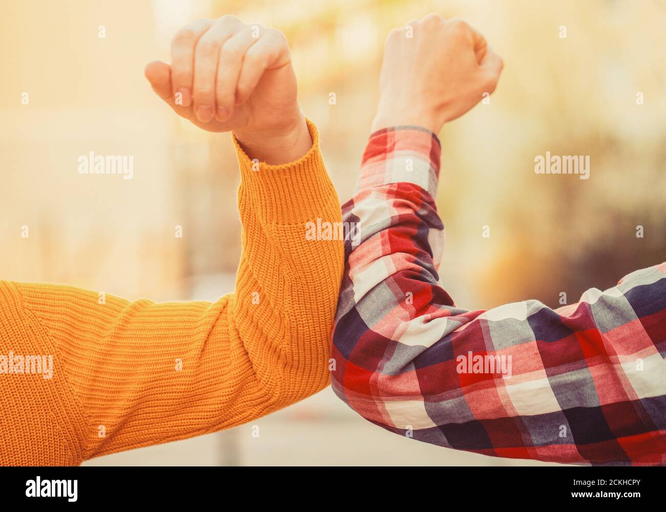 Closeup elbow bump. Elbows bump. Health care concept. Social distancing ...