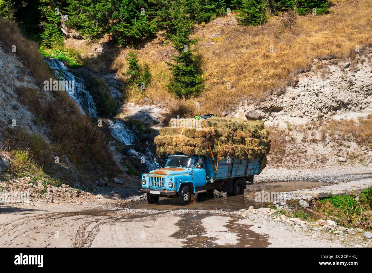 Truck loaded with hay rides on goderdzi pass, Ajara Stock Photo - Alamy