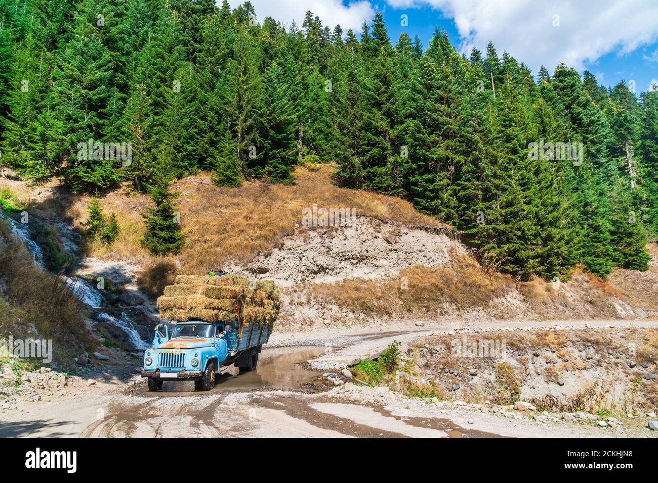 Truck loaded with hay rides on goderdzi pass, Ajara Stock Photo - Alamy