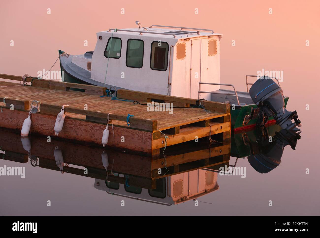 Traditional wooden boat at dock in early morning light Stock Photo - Alamy