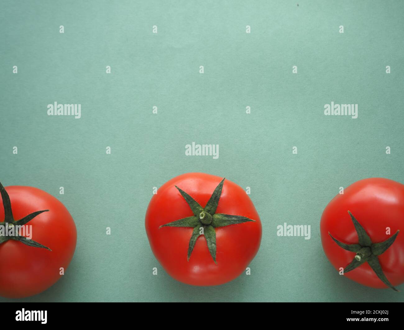 Three red tomatoes Stock Photo - Alamy