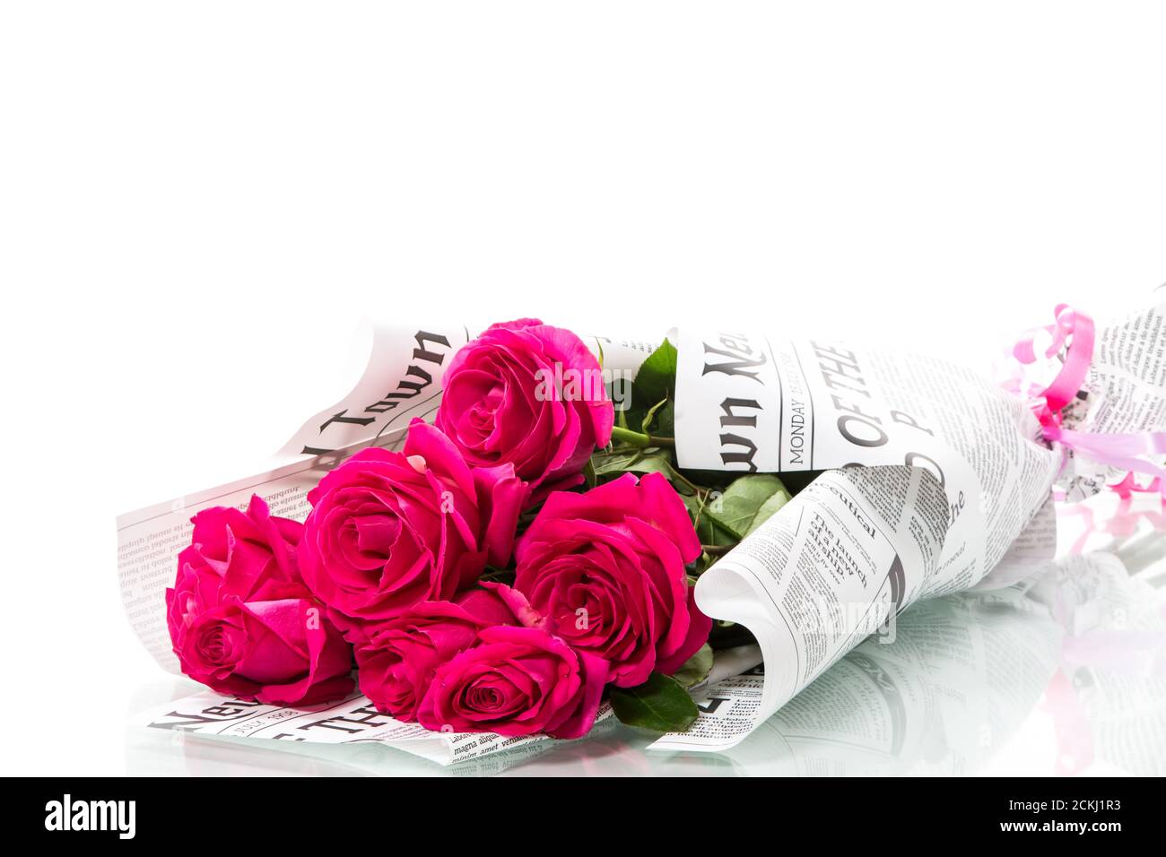 bouquet of beautiful red roses in newspaper wrapper Stock Photo - Alamy