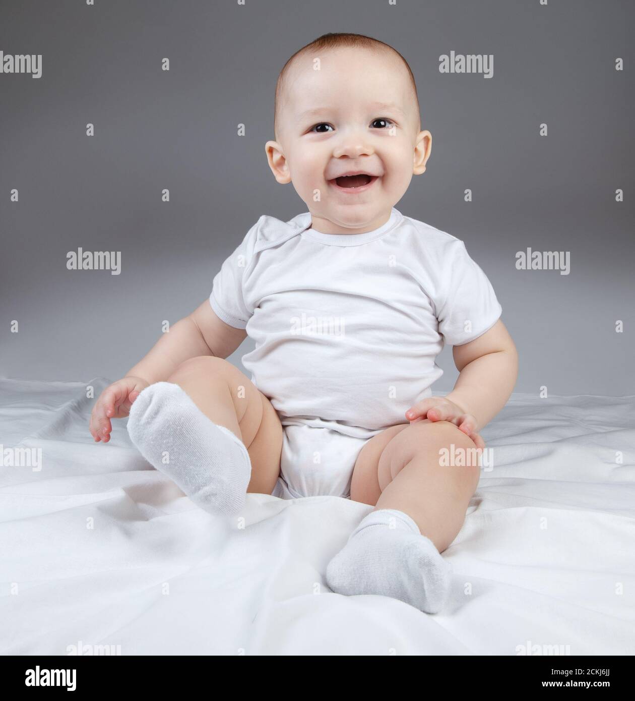 Image of a ten-month-old baby on a white background Stock Photo - Alamy