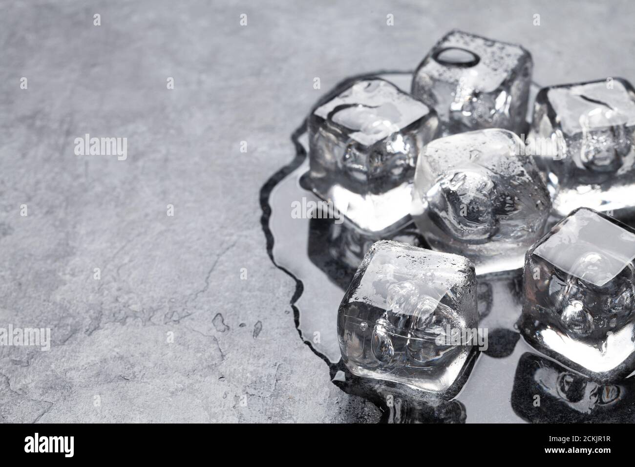 Ice cubes and water drops on stone table with copy space Stock Photo ...