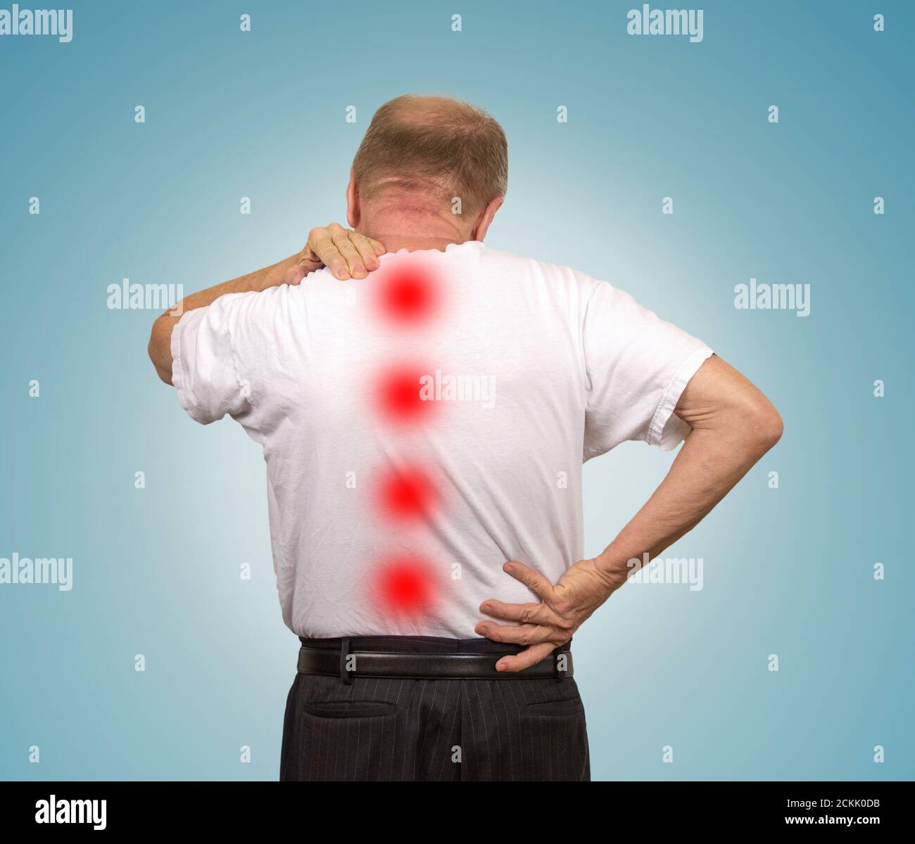 Senior elderly man with backache isolated on light blue background ...