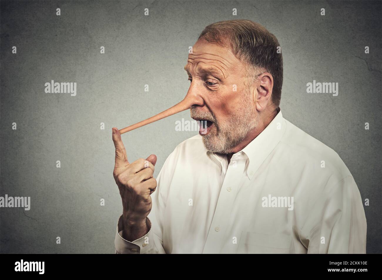 Man with long nose shocked surprised isolated on grey wall background ...