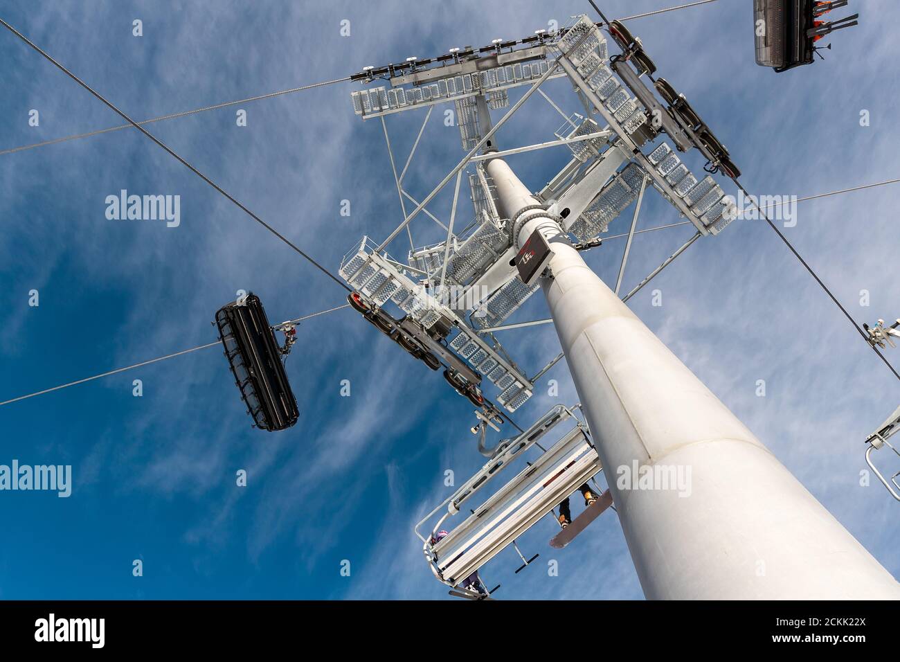 Bottom up overhead view of big metal pillar with Ski lift ropeway ...