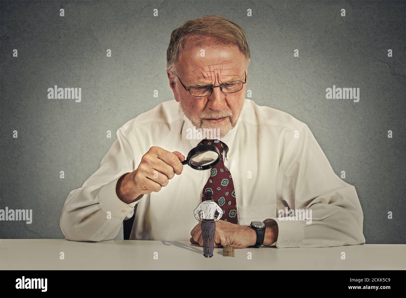 Curious corporate senior businessman skeptically meeting looking at ...