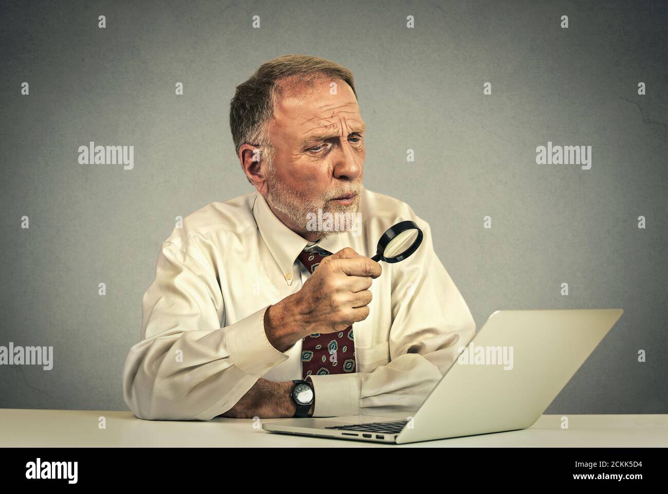 Curious. Portrait senior man investigator working looking through ...