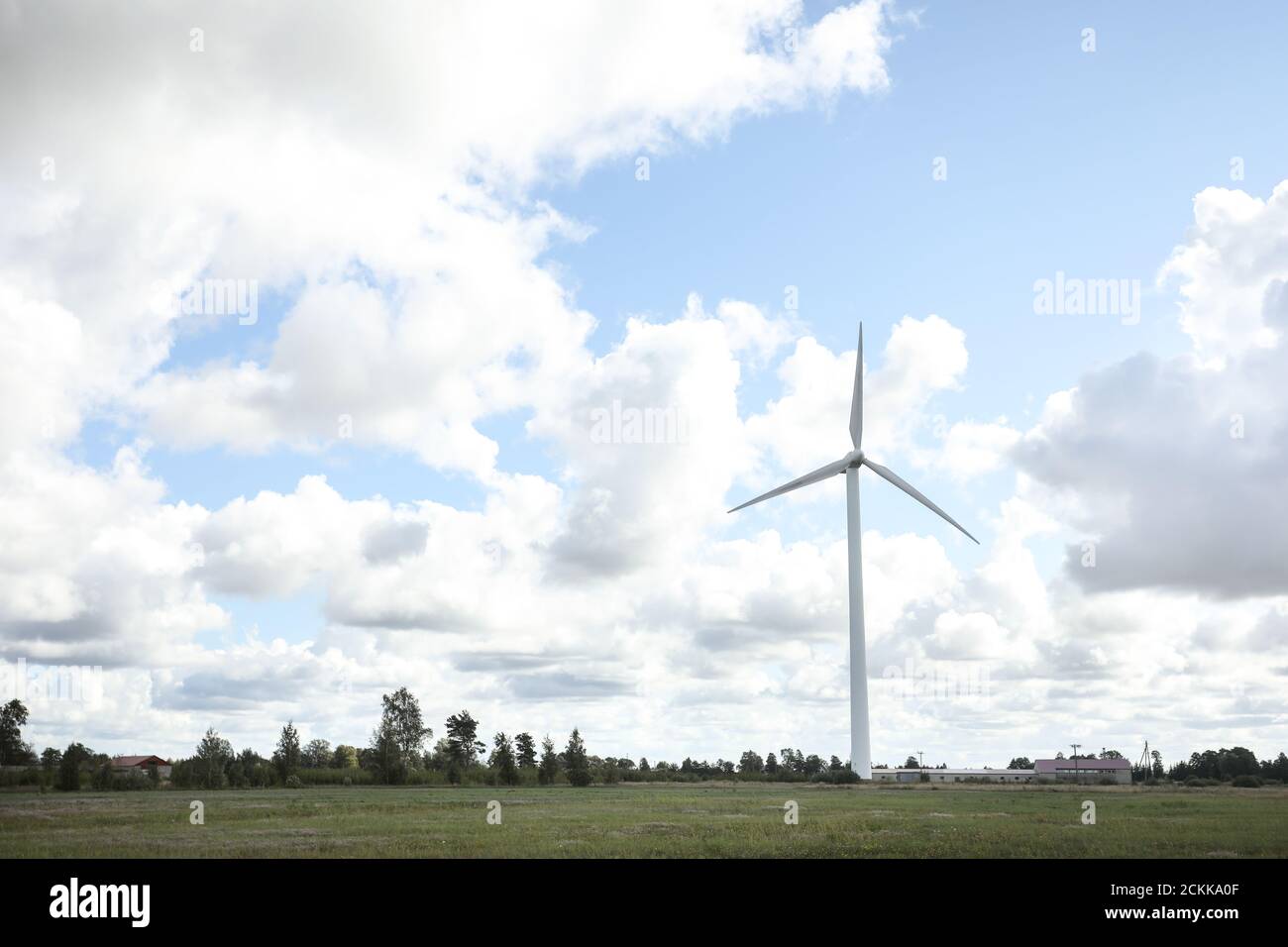 Wind turbine in a sunny day with blue sky and clouds. Wind farm eco ...