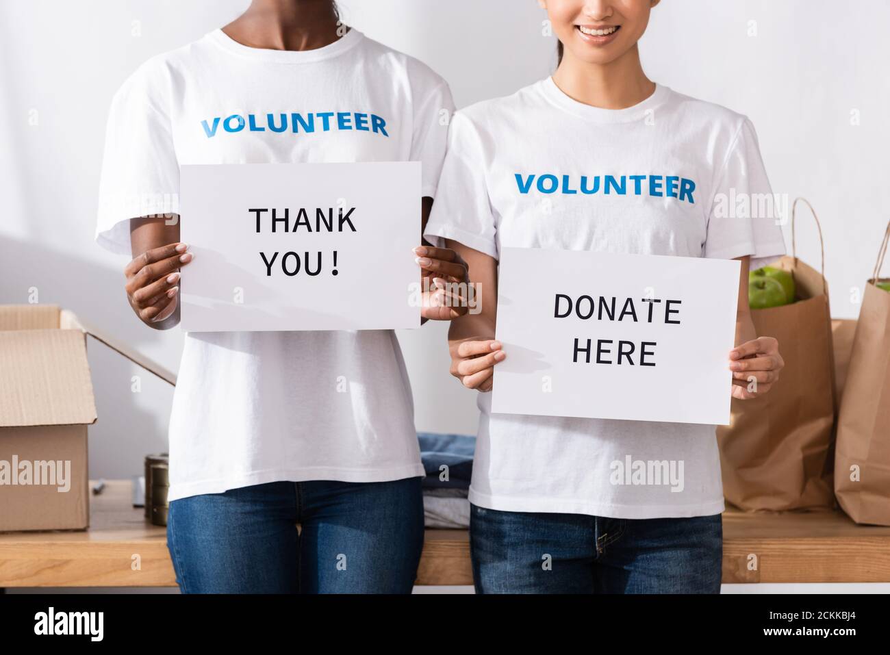 Two young women holding signs hi-res stock photography and images - Alamy