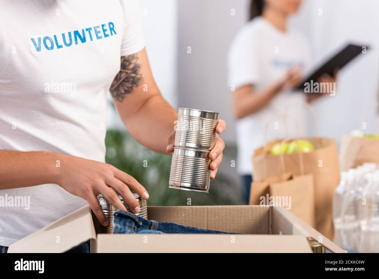 Woman putting cans food hi-res stock photography and images - Alamy