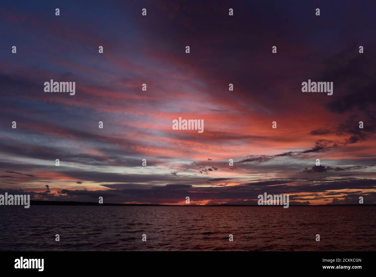 sky colors at sunset over cold water Stock Photo - Alamy