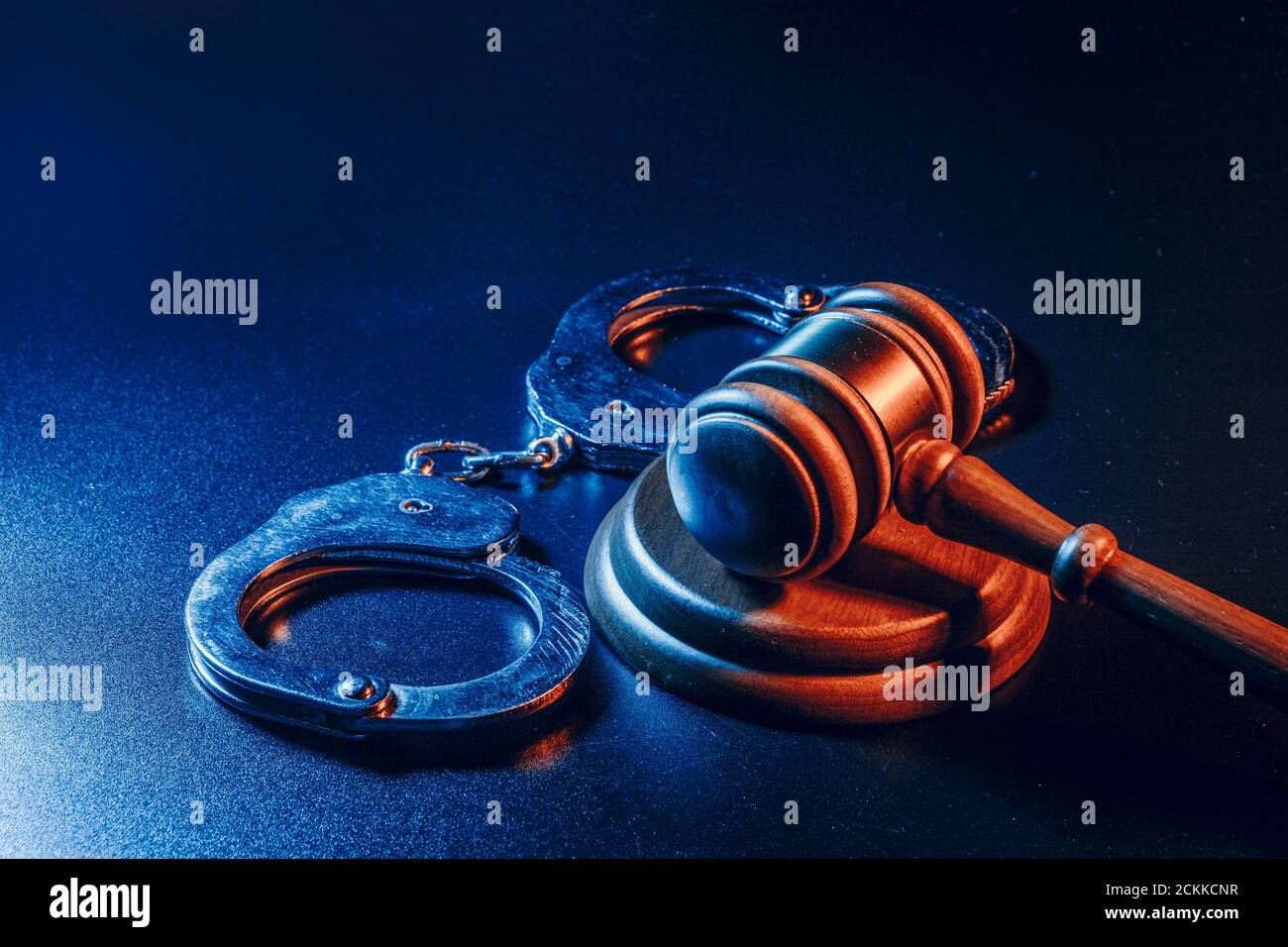 Judge gavel and handcuffs on dark black background Stock Photo - Alamy