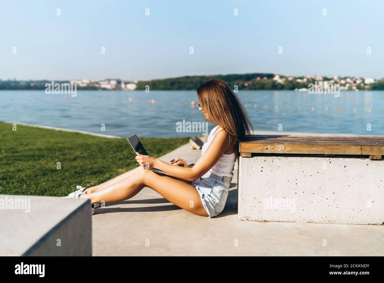 Pretty young girl using laptop outdoor in the city park Stock Photo - Alamy